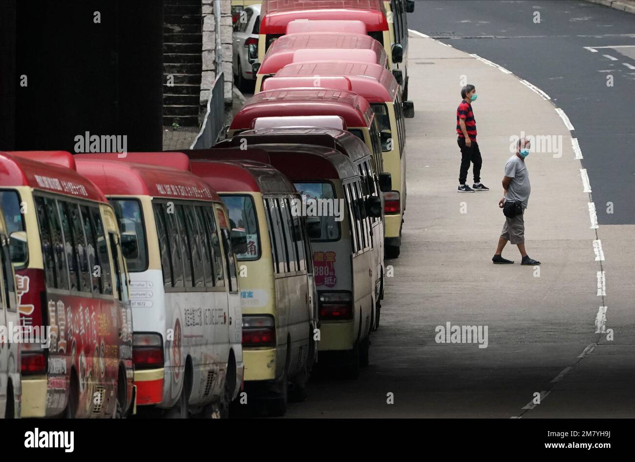 A queue of red mini bus waiting for passengers in Tsz Wan Shan, where ...