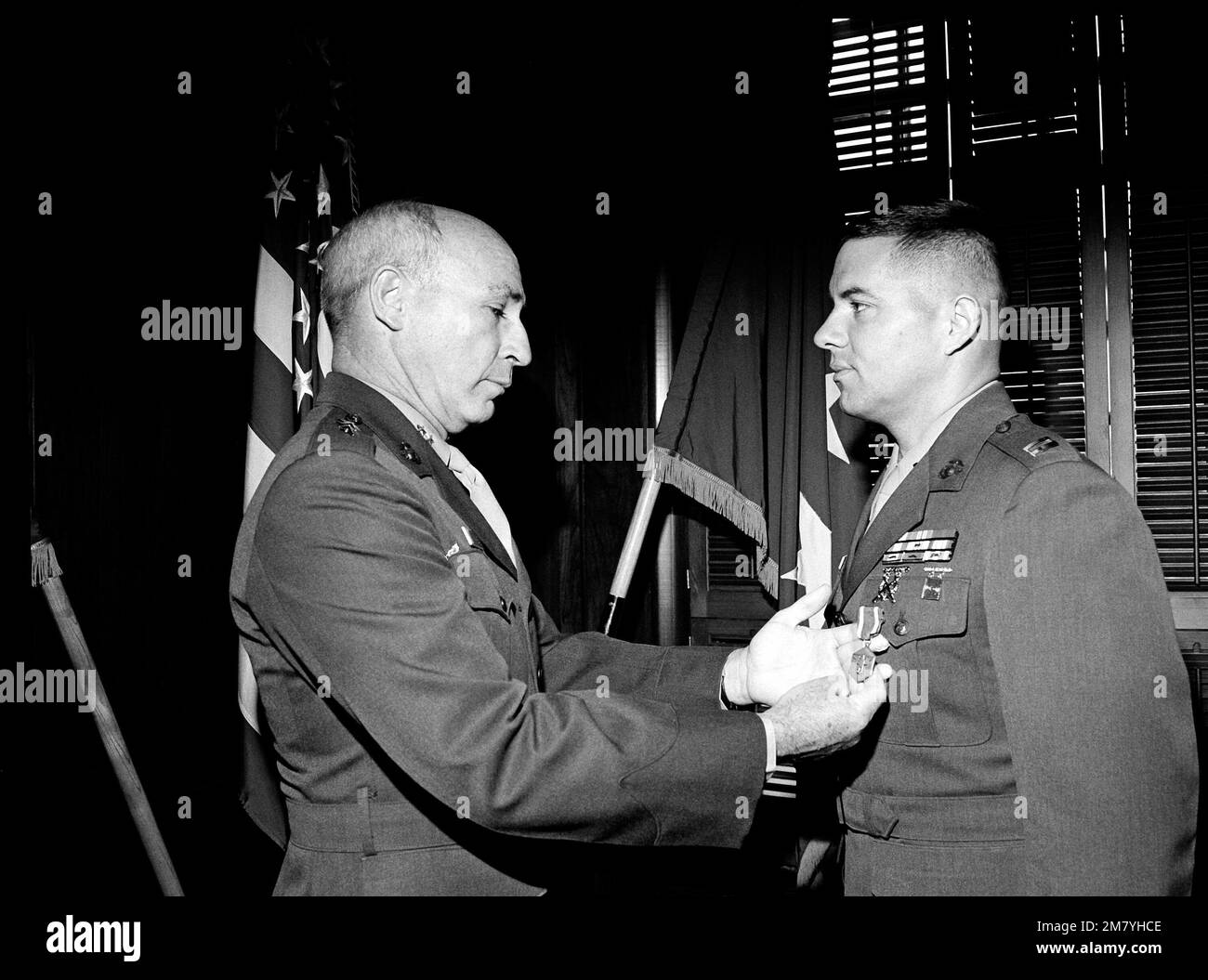 MGEN James McMonagle (left) presents a Navy Commendation Medal to CAPT ...