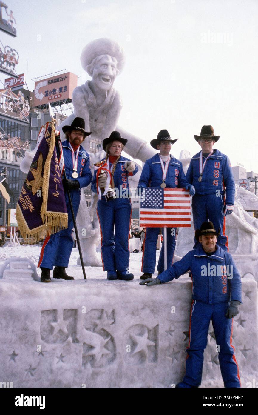 Members of the U.S. Snow Sculpture Team pose in front of their snow ...