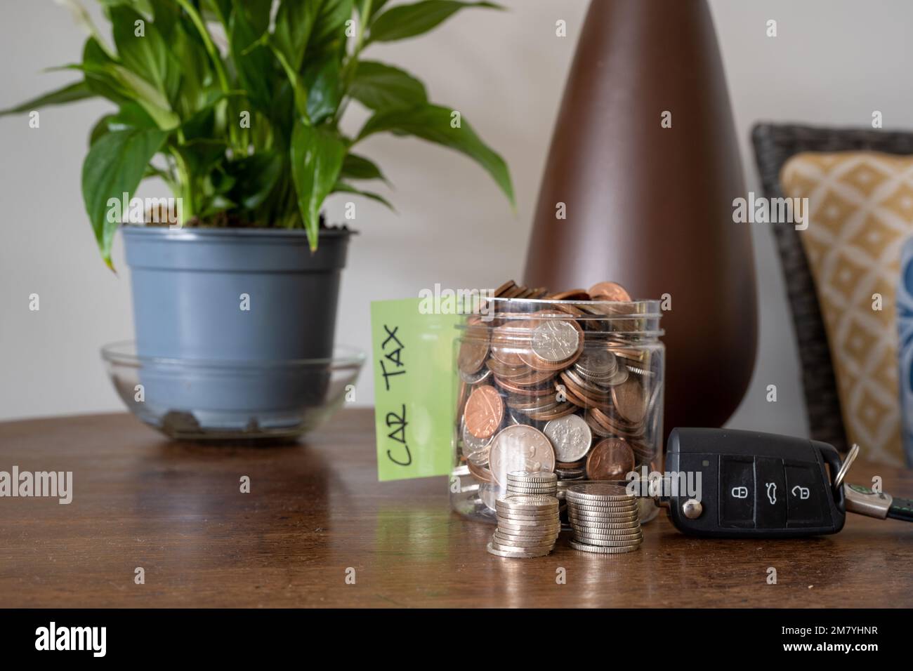 savings jar with loose change towards the cost of yearly car tax and ...