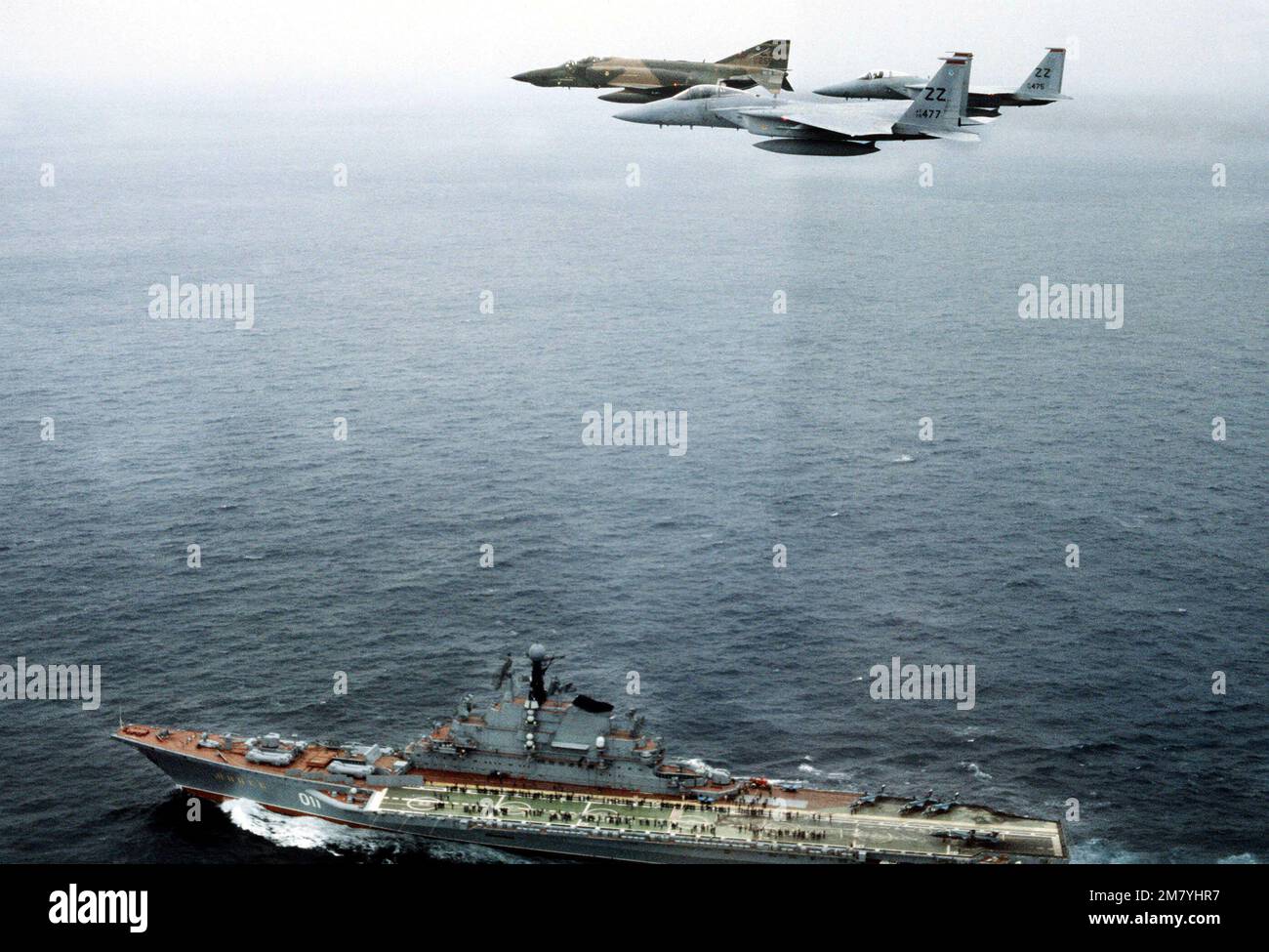 An air-to-air left side view of an F-4 Phantom II and two F-15 Eagle ...