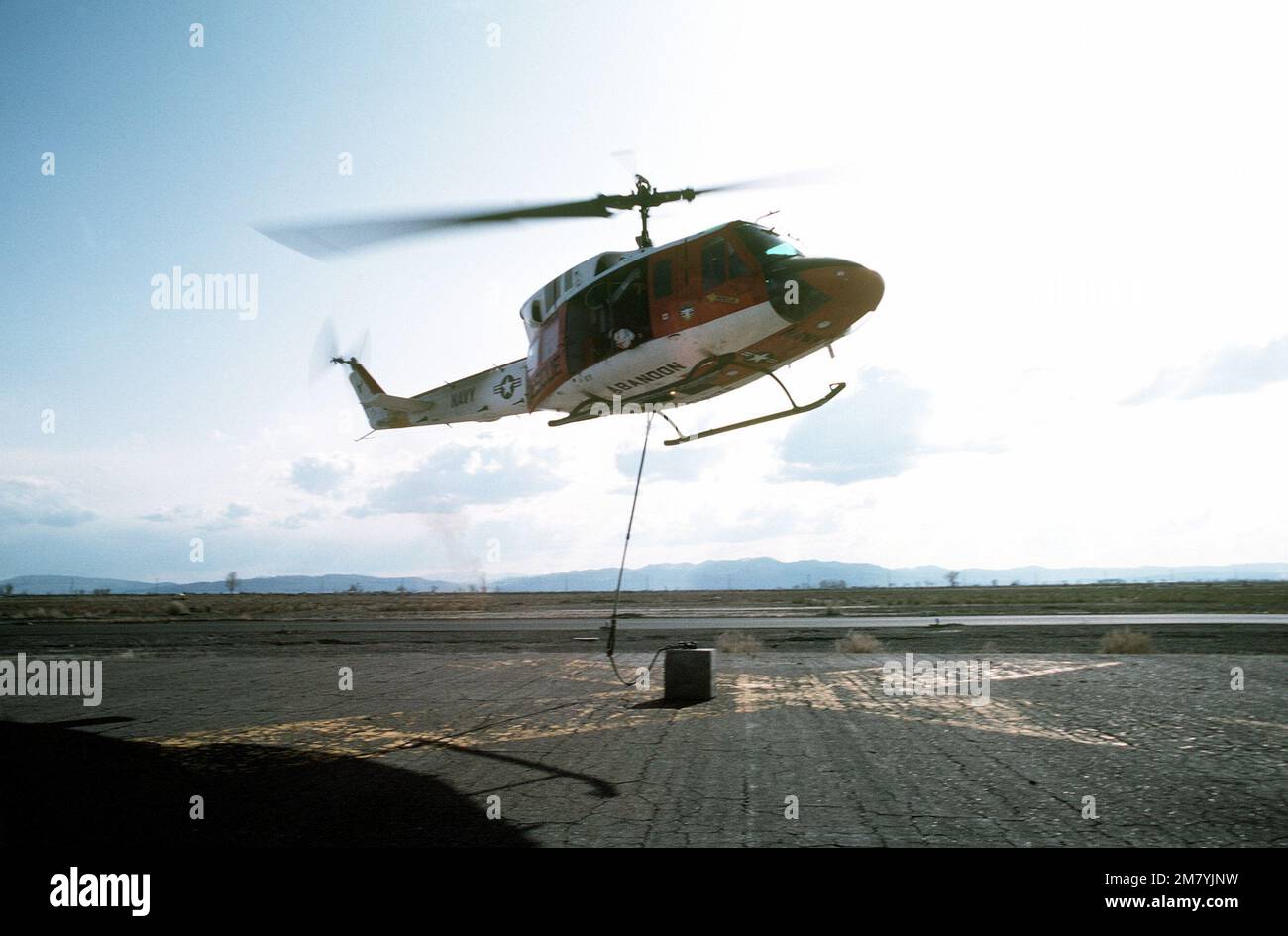 A view of a UH-1N Iroquois helicopter as it lifts a cement weight ...