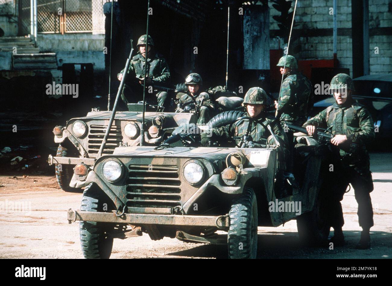 Marines patrol a city street aboard jeeps, during their participation ...