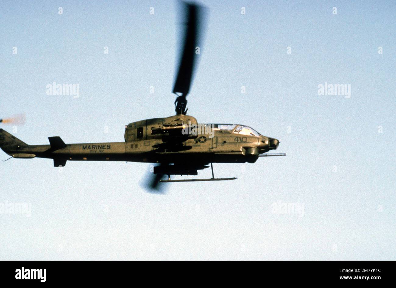 A right underside view of a Marine AH-1J Sea Cobra helicopter on patrol ...