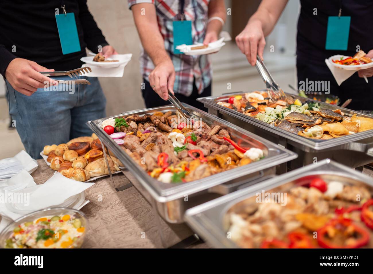 People choosing fresh prepared food from buffet table Stock Photo - Alamy