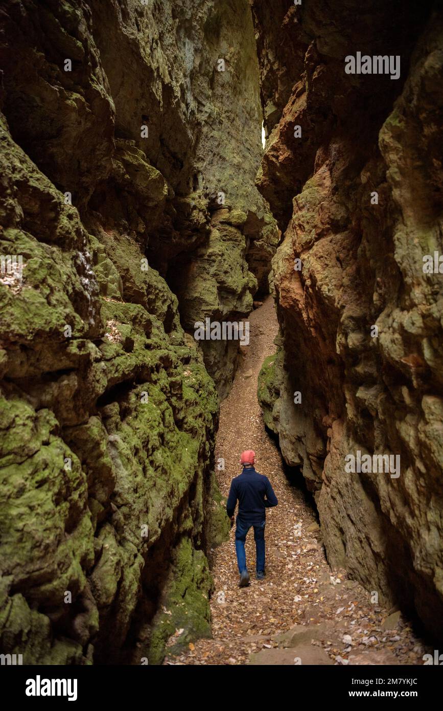 Hiker inside the Avencs de la Febró, a fissure about 30 meters deep in ...