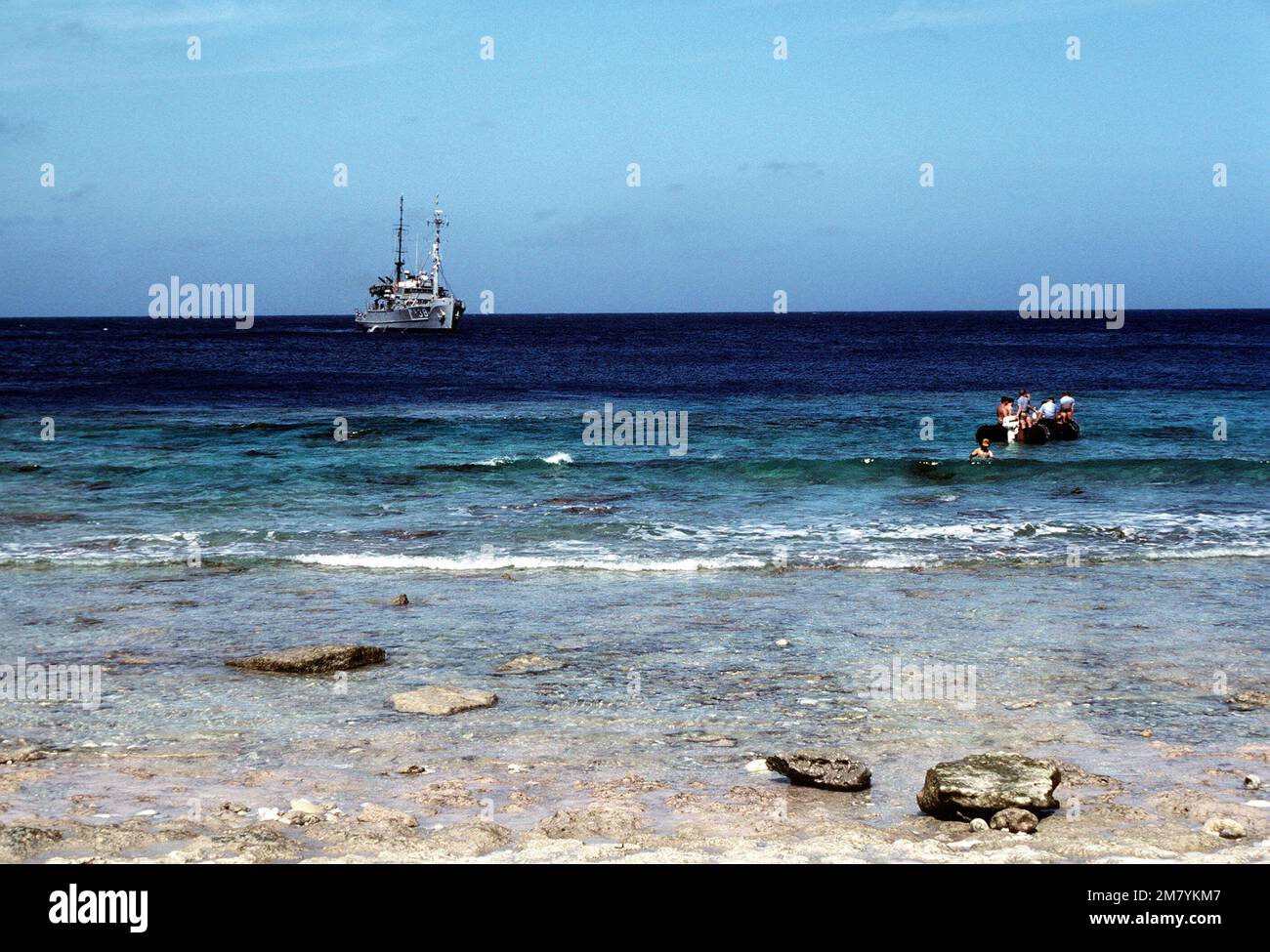 The salvage ship USS BOLSTER (ARS 38) prepares to set anchor offshore ...