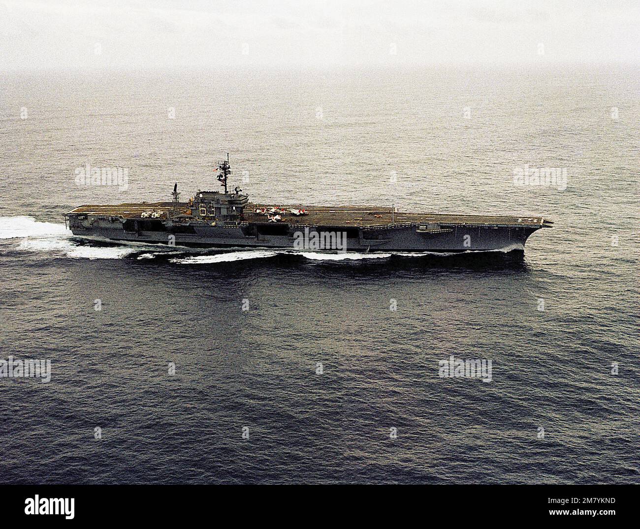 An aerial starboard beam view of the aircraft carrier USS KITTY HAWK ...