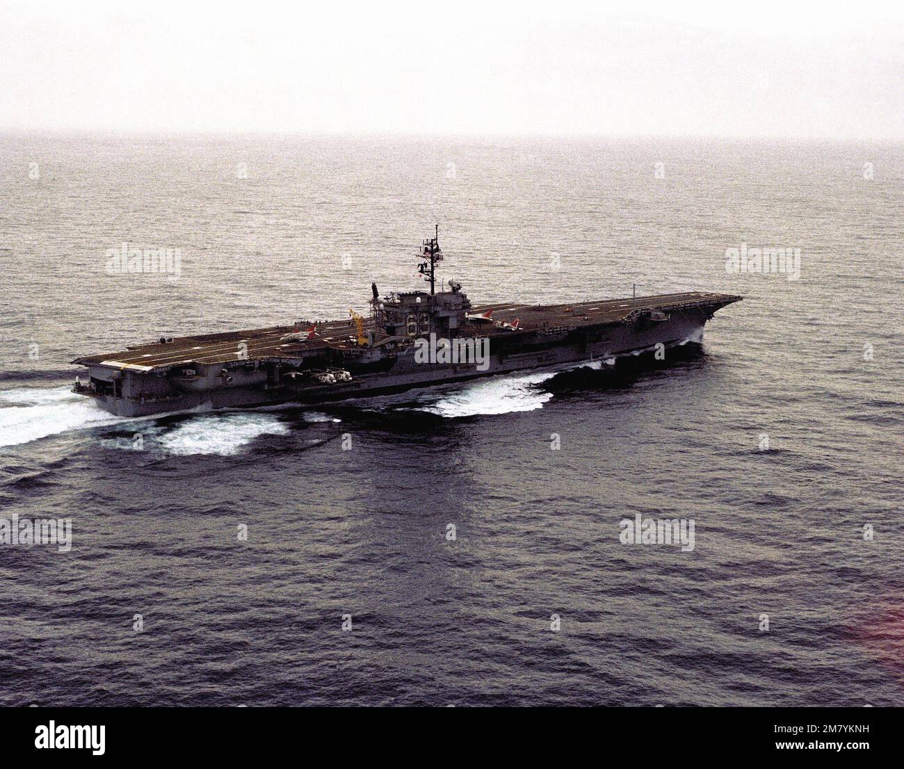 An aerial starboard quarter view of the aircraft carrier USS KITTY HAWK ...