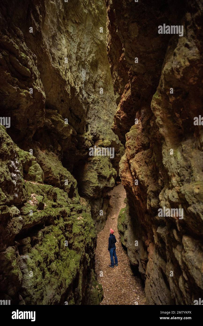 Hiker inside the Avencs de la Febró, a fissure about 30 meters deep in ...