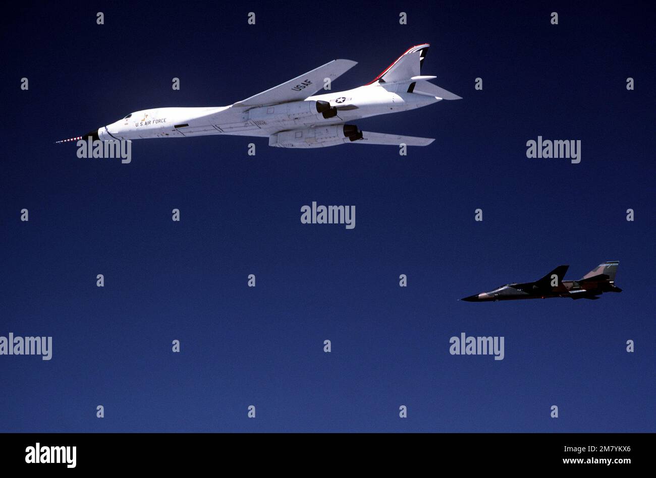 An air-to-air left side view of a B-1B bomber with an F-111 aircraft ...