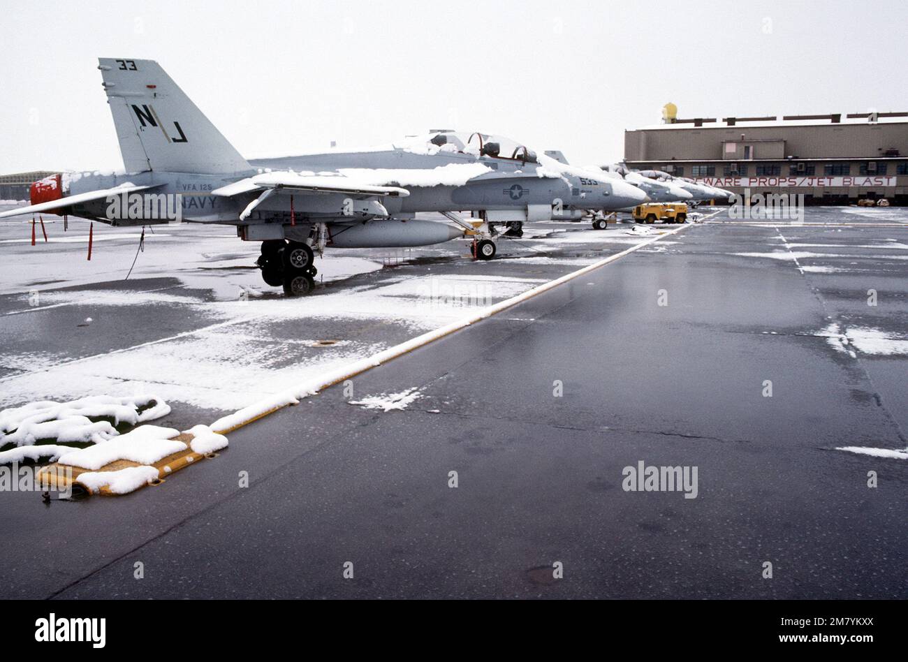 A right side view of snow covered F/A-18 Hornet aircraft from Marine ...