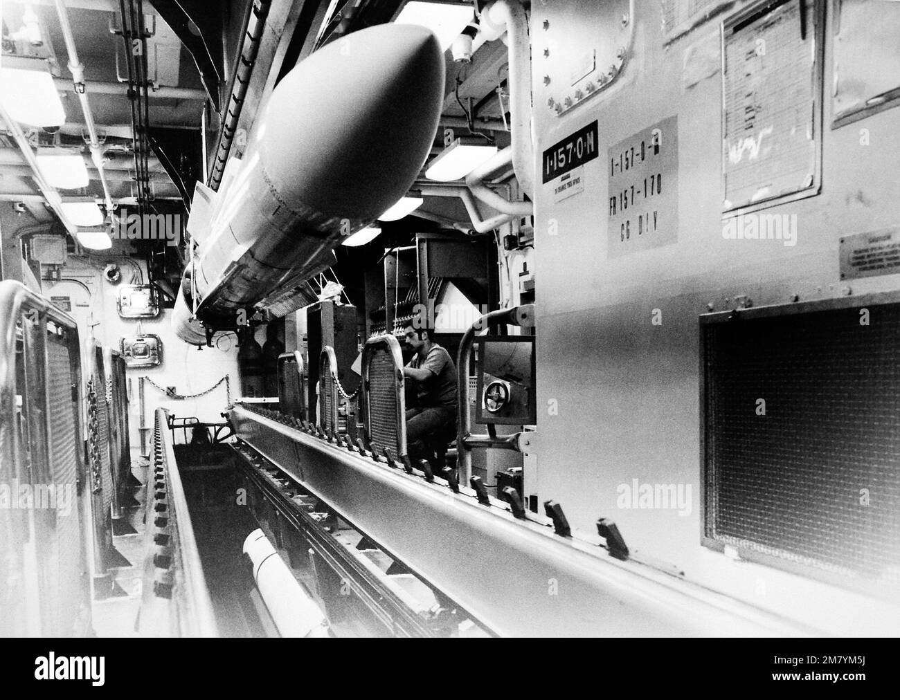 An SM-2 (ER) missile is loaded on the missile house rail aboard the ...
