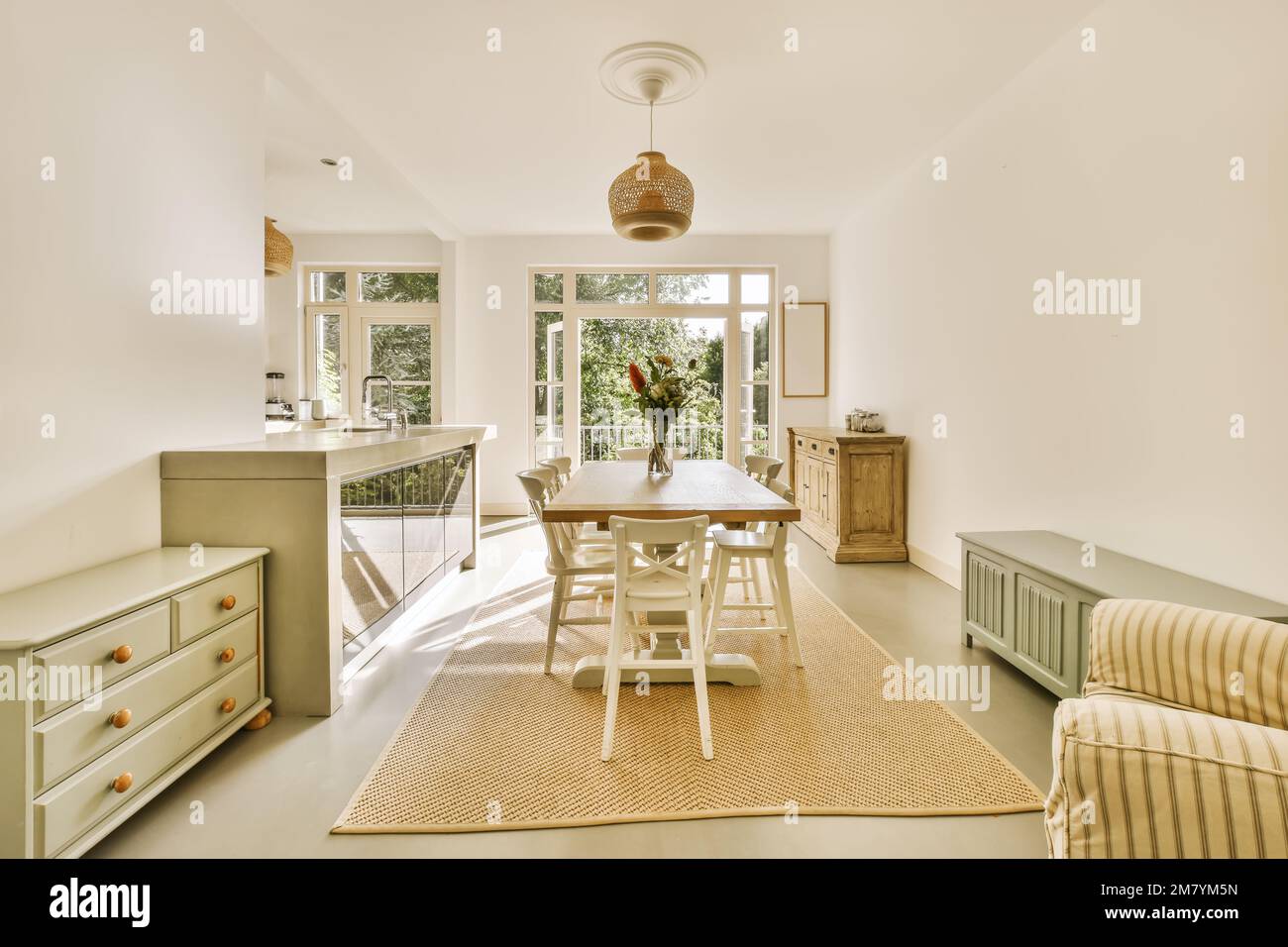 a living room with a dining table and two couches in front of the ...