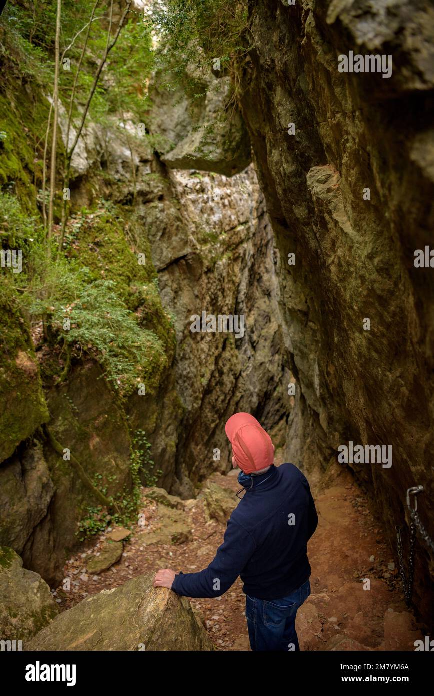 Hiker inside the Avencs de la Febró, a fissure about 30 meters deep in ...