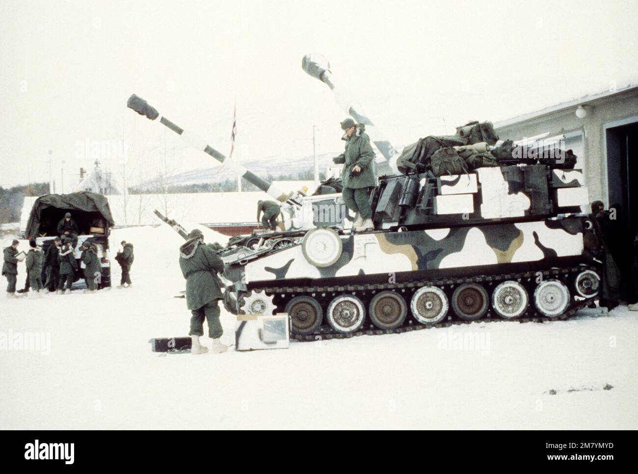 Marines of the 2nd Tank Battalion perform maintenance on two M-109 self ...