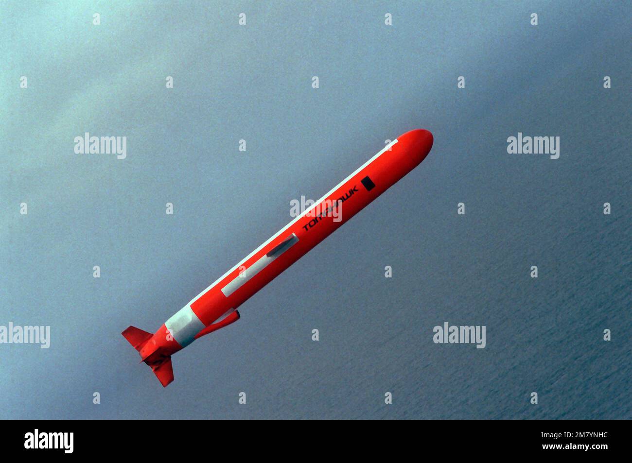 An air-to-air side view of a BGM-109 Tomahawk missile in-flight. The ...