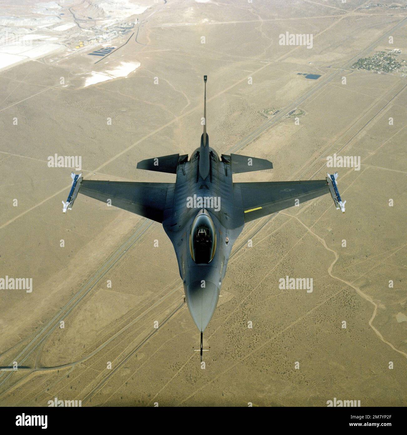 An air-to-air top front view of an F-16 Fighting Falcon aircraft with a ...