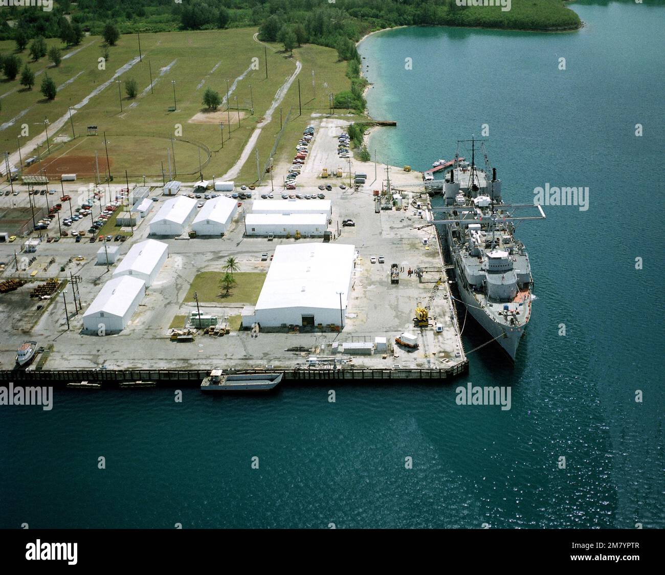 An aerial view of the submarine tender USS PROTEUS (AS 19) moored in ...