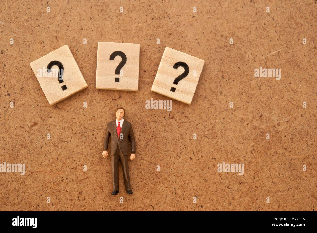 miniature figurine with question marks around him Stock Photo - Alamy