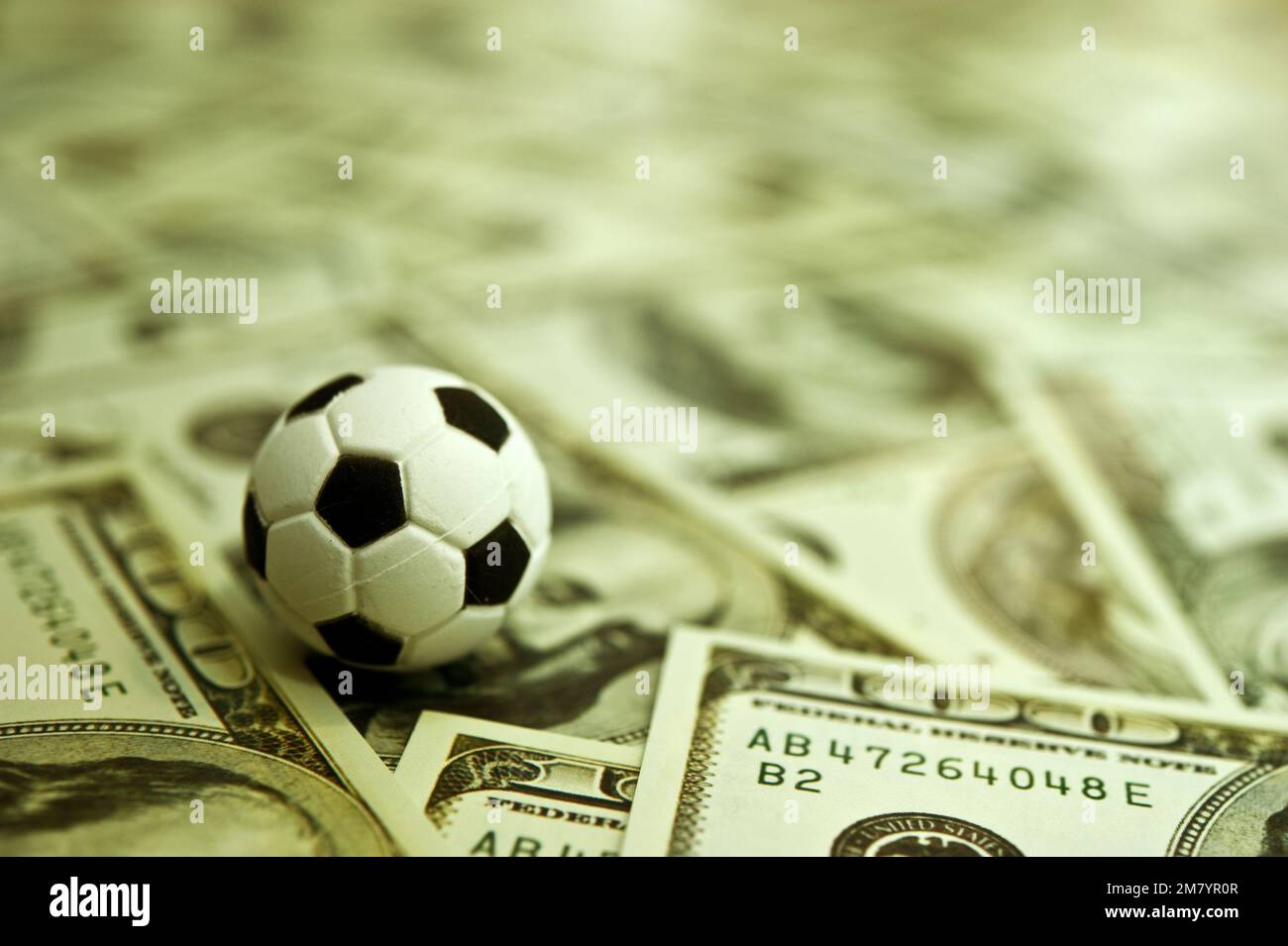 soccer ball and dollars, business and sport concept Stock Photo - Alamy