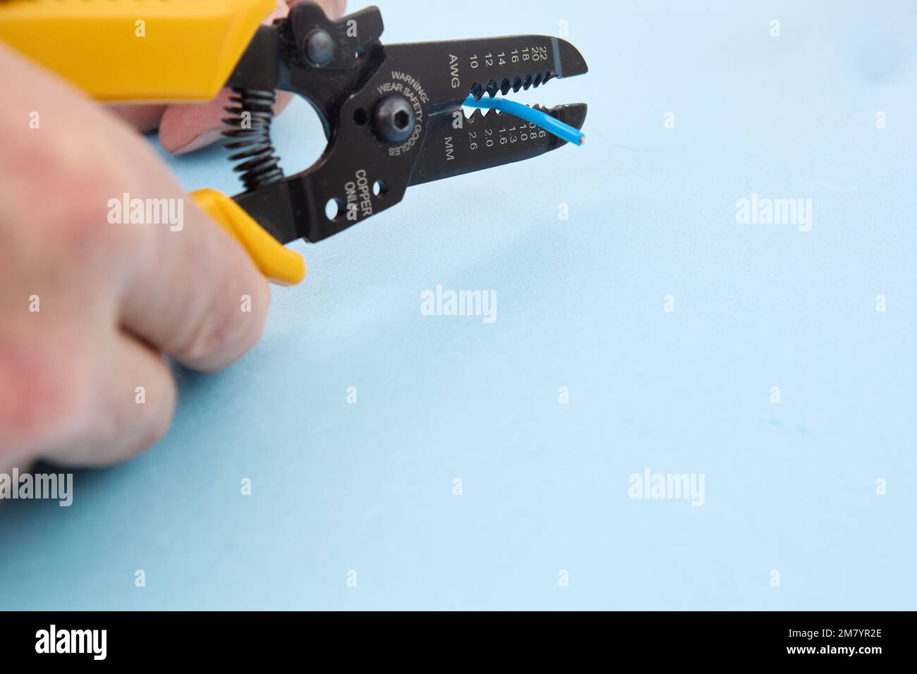 Wire stripping tool look like pliers with number of notches set in jaws ...