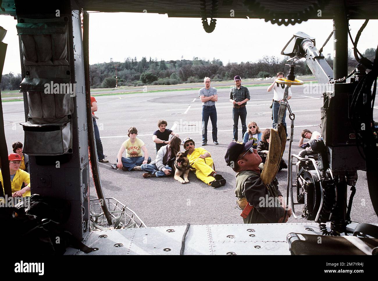 A view from the interior of a UH-1N Iroquois helicopter of a member of ...