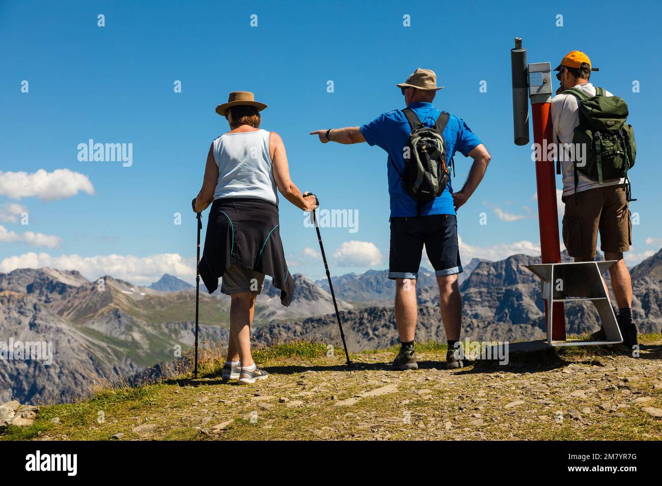 HIKERS ADMIRING THE VIEW OF THE ALPINE LANDSCAPE FROM THE WEISSHORN ...