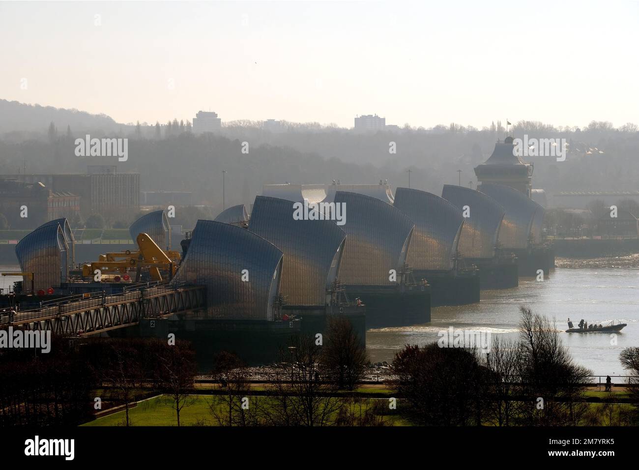 A boat passes through the Thames Barrier on the River Thames in London ...