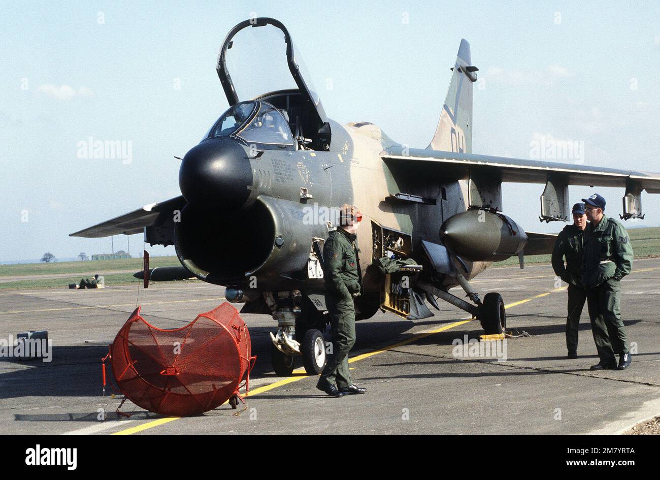 A left front view of an A-7D Corsair II aircraft as ground crewmen ...