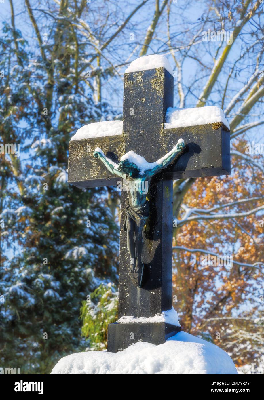 Snow covered historic crucifix in a cemetry Stock Photo - Alamy