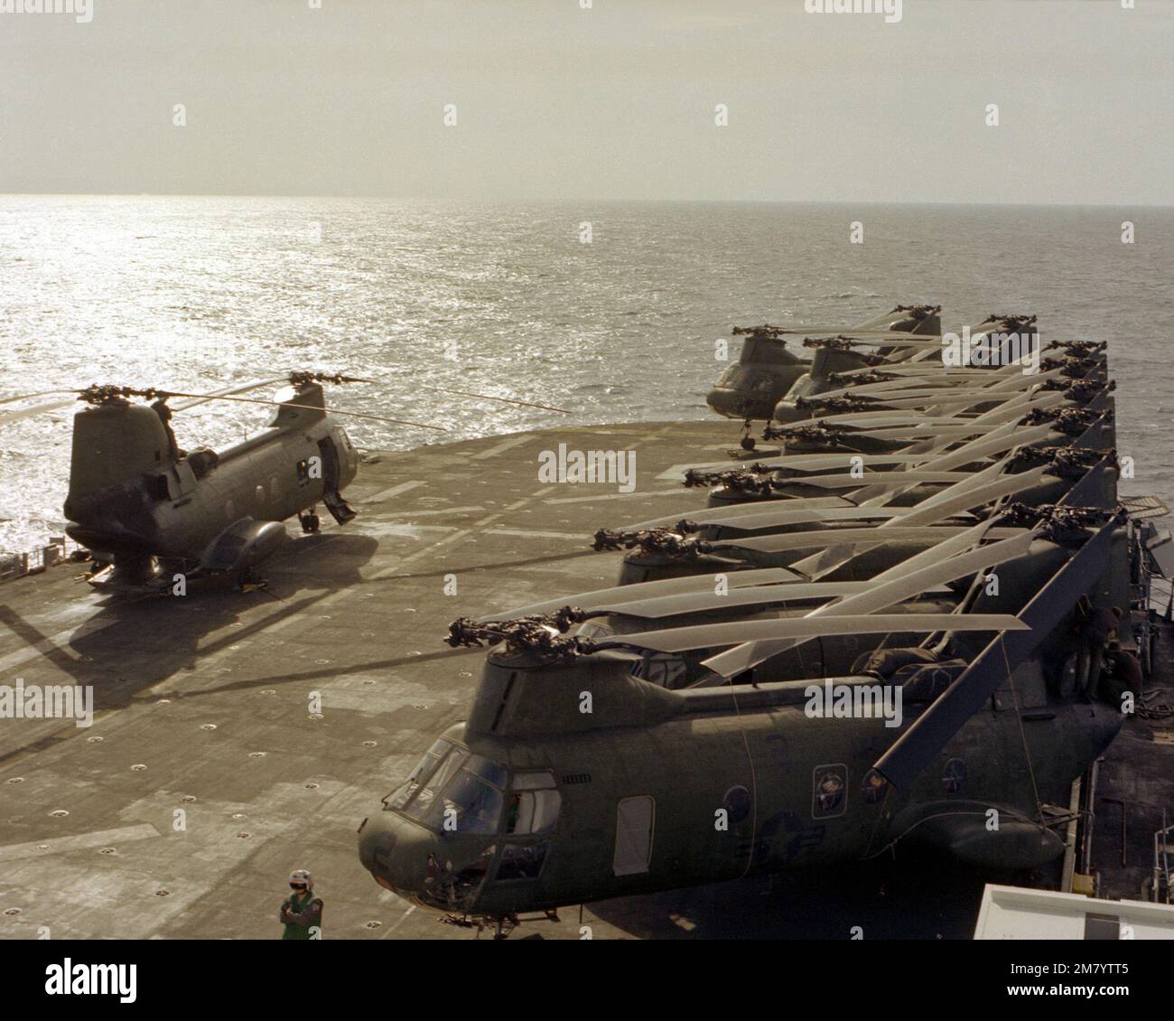 CH-46 Sea Knight helicopters line the flight deck of the amphibious ...