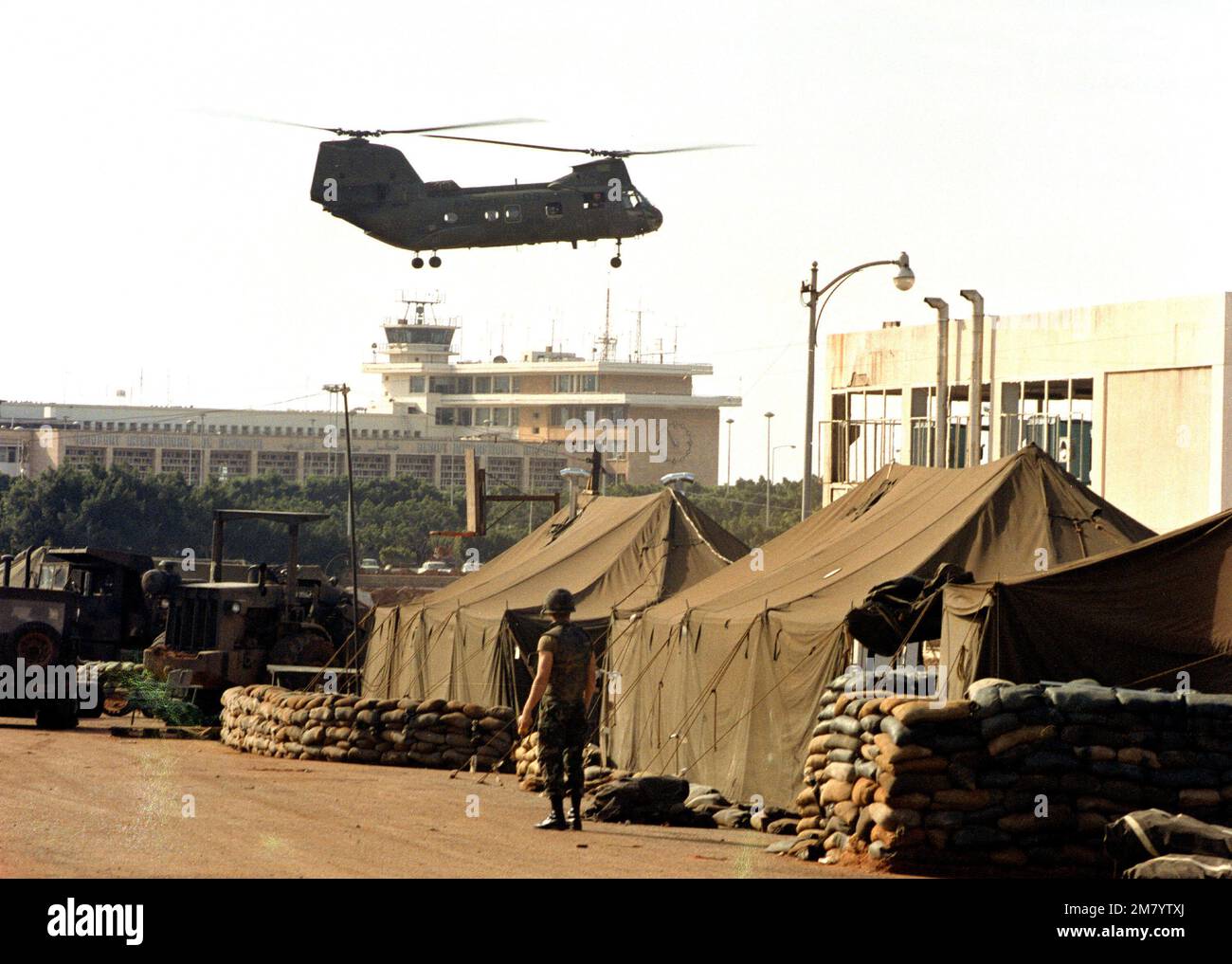 A CH-46E Sea Knight helicopter hovers above the U.S. Marine Corps ...