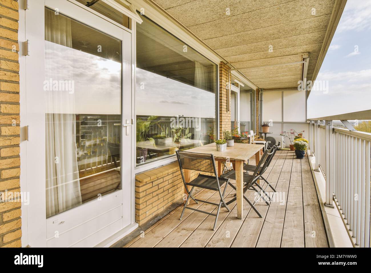 a balcony with chairs and table on it's side, as seen from the outside ...