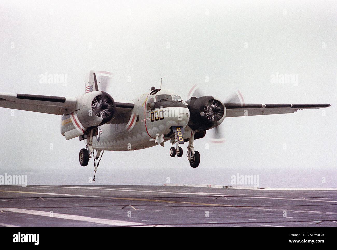 A C-1A Trader cargo/transport aircraft just before it lands aboard the ...
