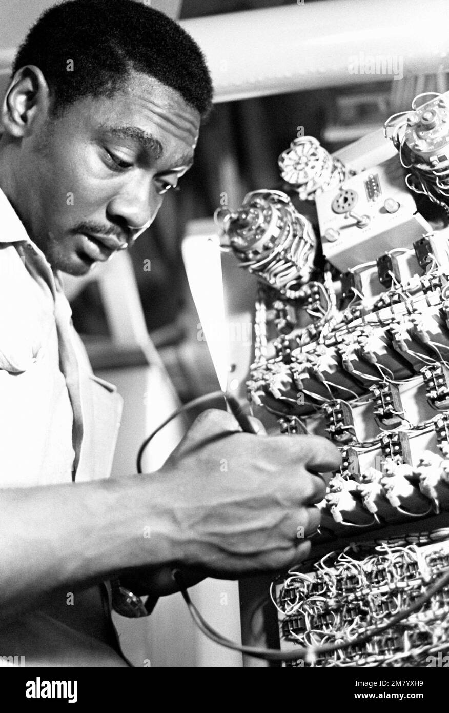 Electronics Technician 2nd Class (ET2) McCoy solders a component in the ...