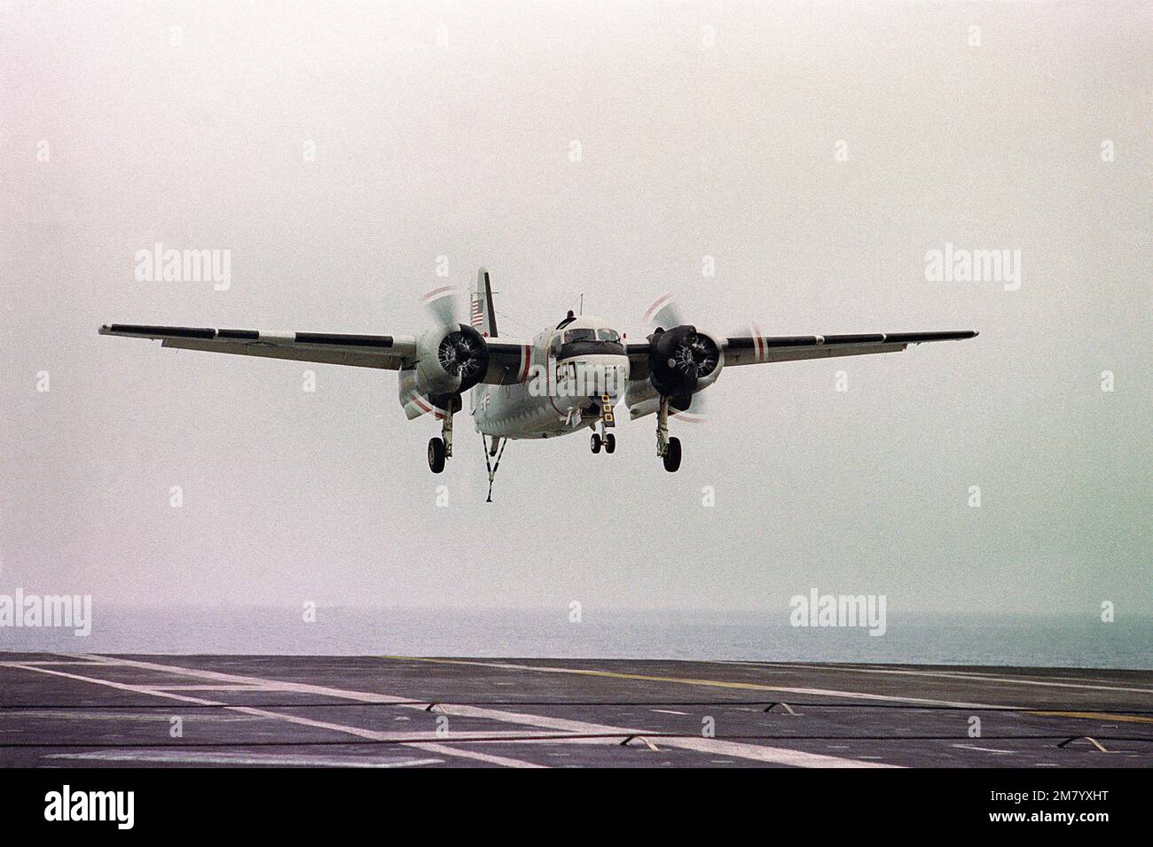 A C-1A Trader cargo/transport aircraft approaches for landing aboard ...