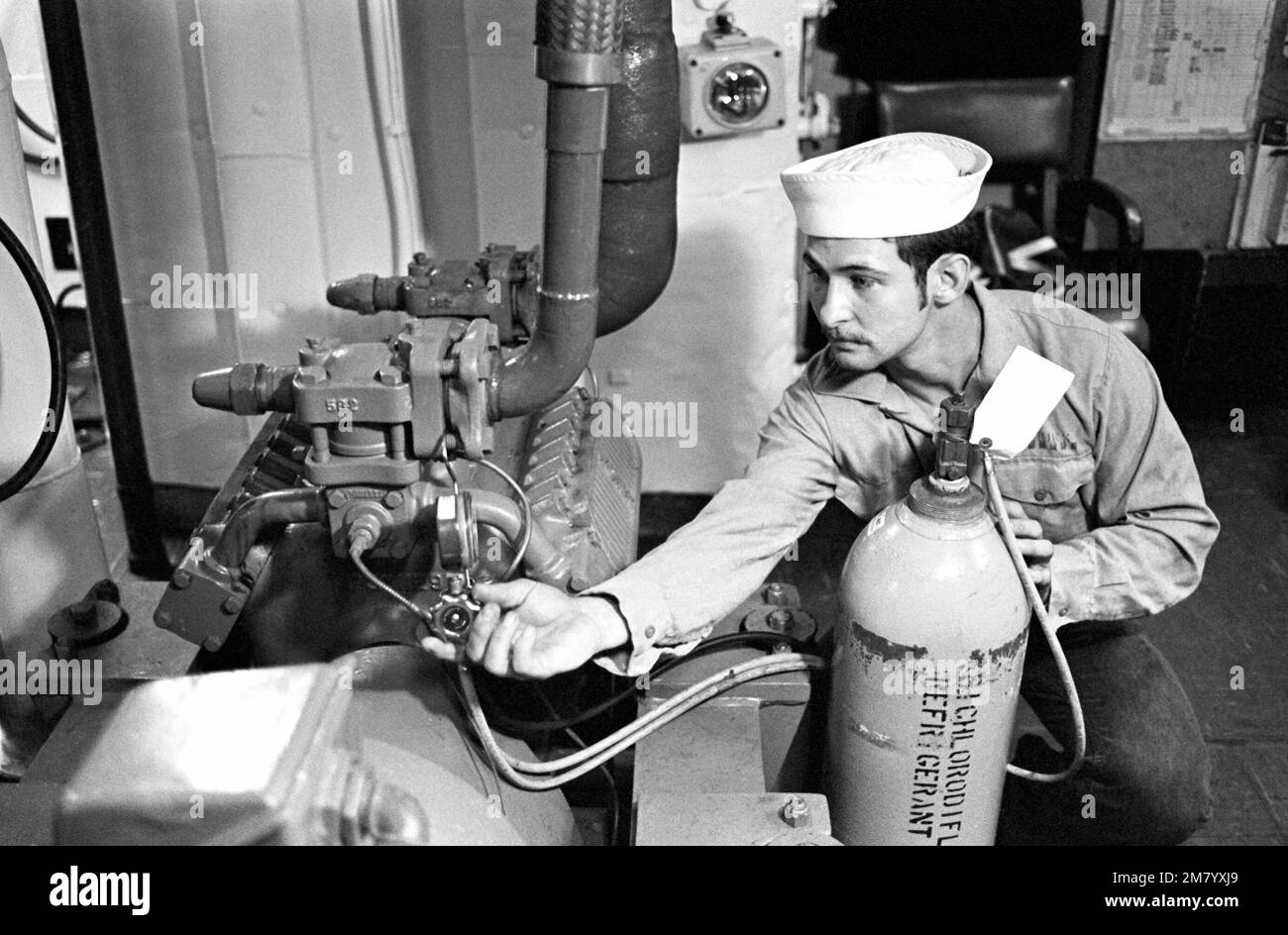 Machinist's Mate Ricky Brooks tests the pressure of an air conditioning ...