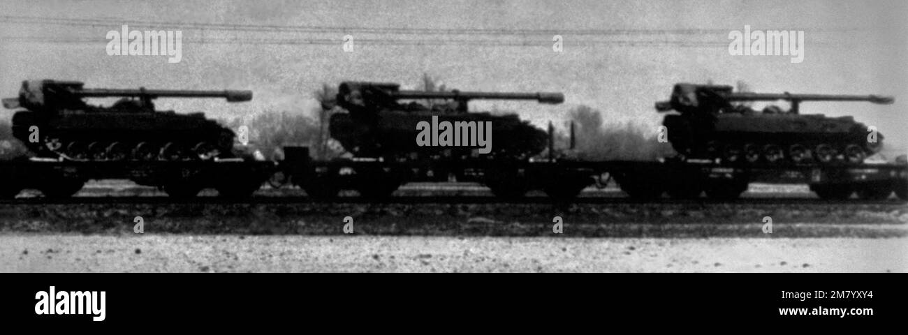 Side view of three Soviet 152mm self-propelled guns being transported ...