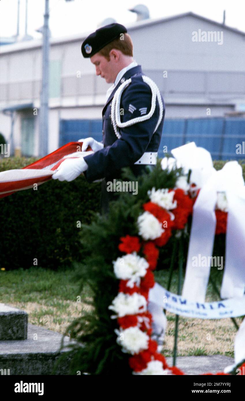 A member of the 475th Air Base Wing Honor Guard folds the flag during a ...