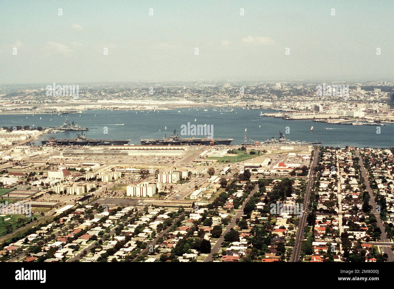 Aerial view of the naval air station and docked US Navy ships. They are ...