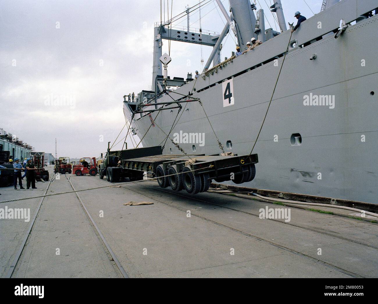 Seabees offload heavy equipment from the amphibious cargo ship USS ...