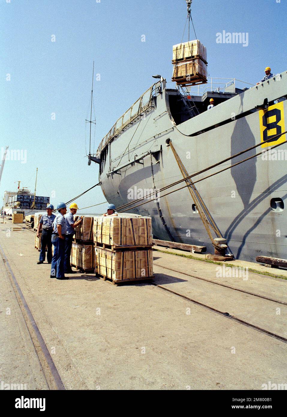 Seabees offload heavy equipment and supplies from the amphibious cargo ...