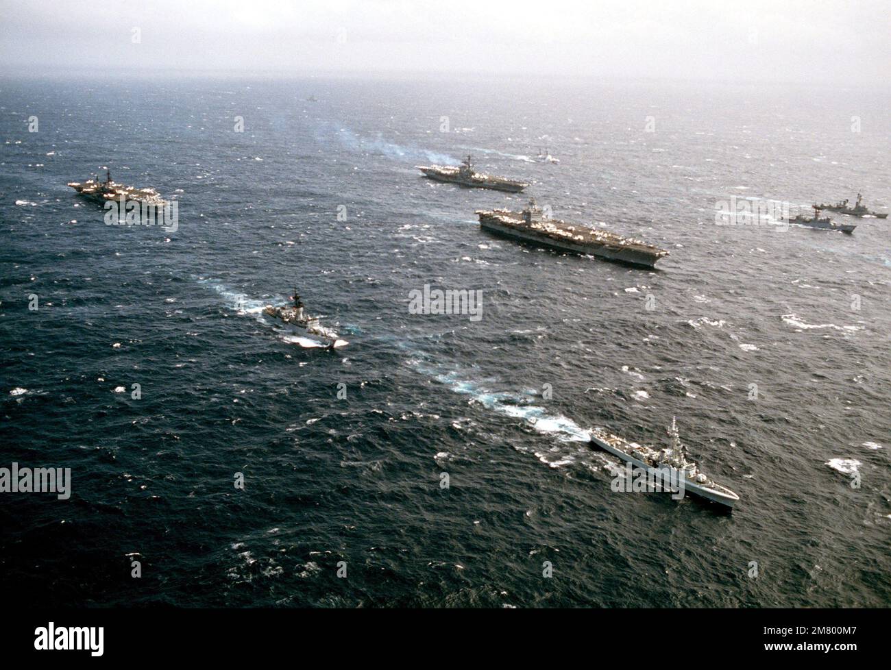 A starboard bow view of the aircraft carriers USS MIDWAY (CV 41), left ...