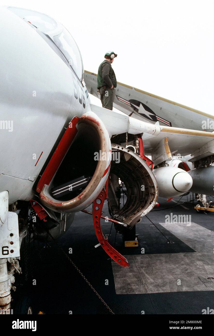 An A-6 Intruder aircraft is serviced aboard the aircraft carrier USS ...