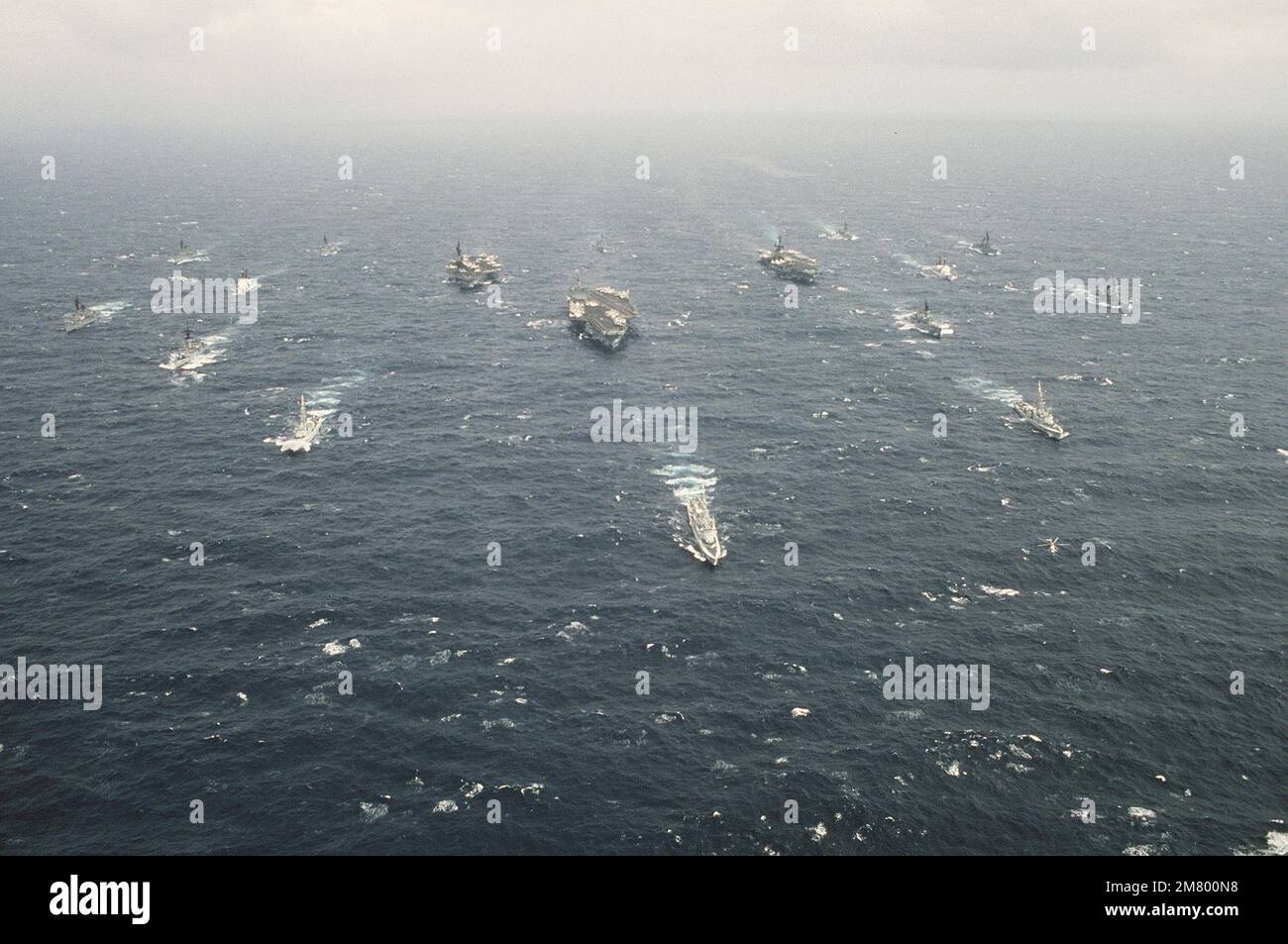 A bow view of the aircraft carriers USS CORAL SEA (CV-43), right, and ...