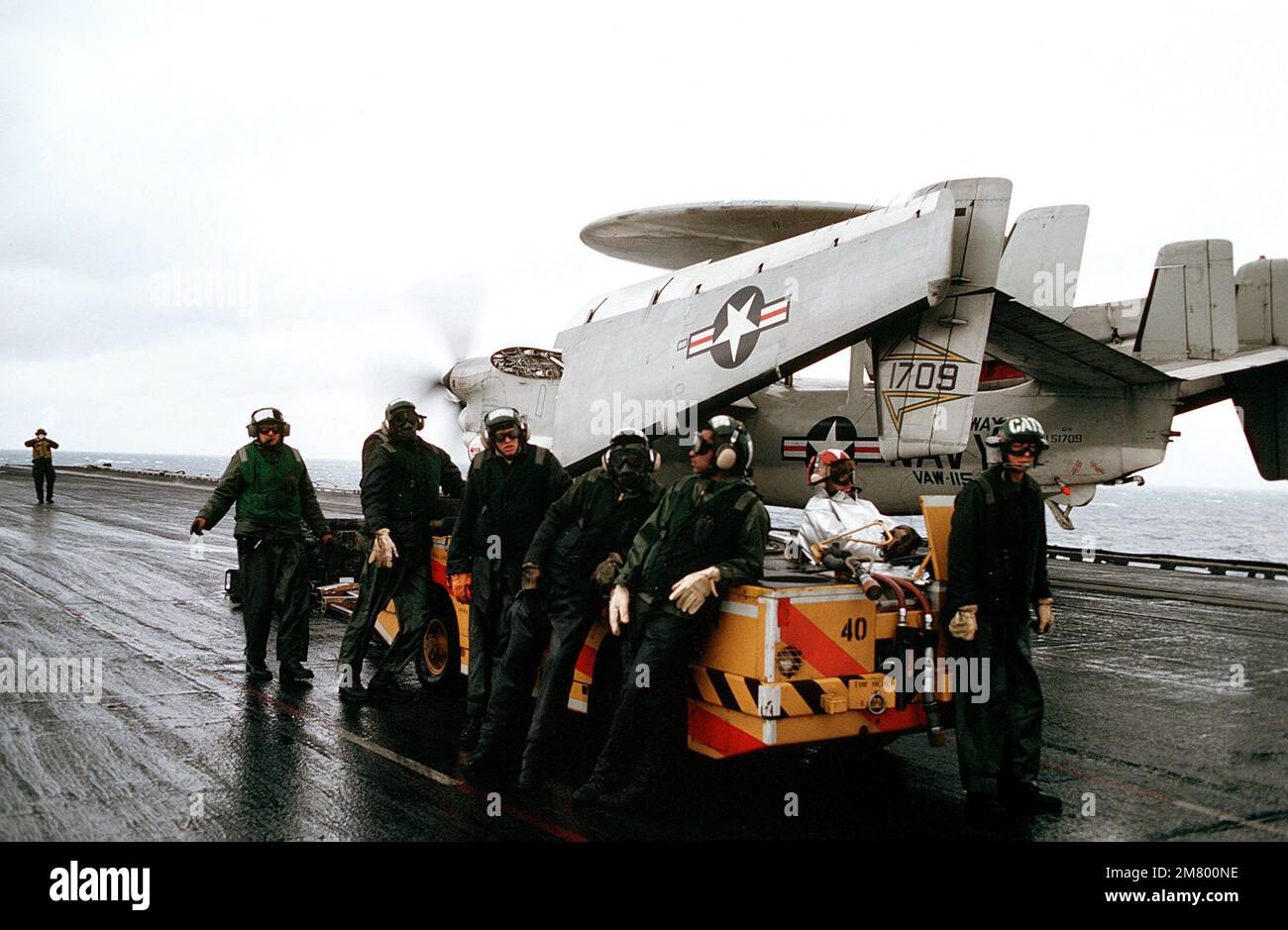 Flight deck crewmen aboard the aircraft carrier USS MIDWAY (CV 41) take ...