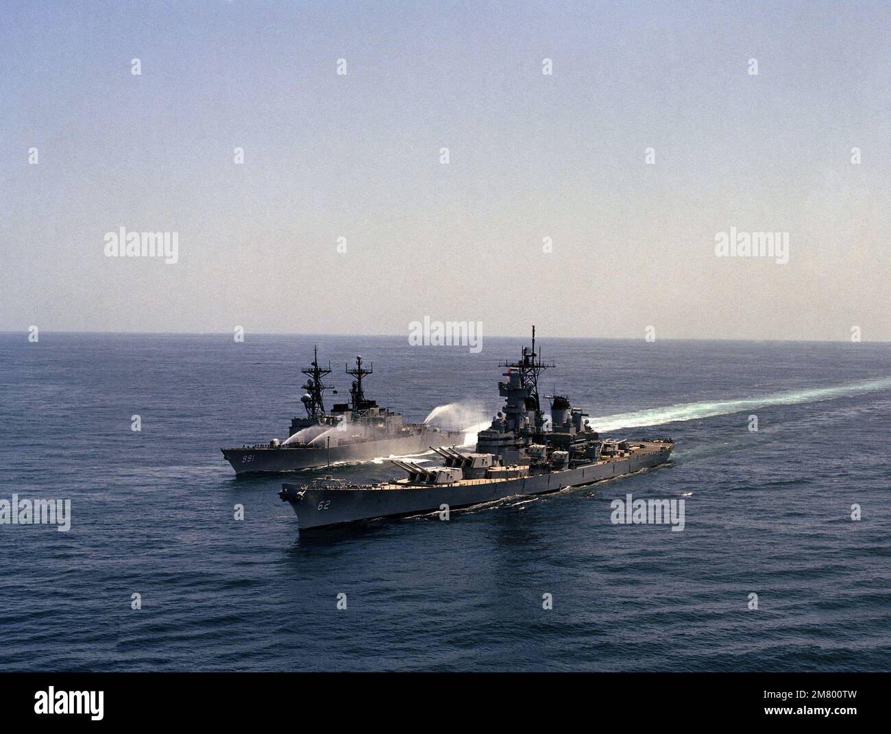 Aerial port bow view of the battleship USS NEW JERSEY (BB 62) underway ...