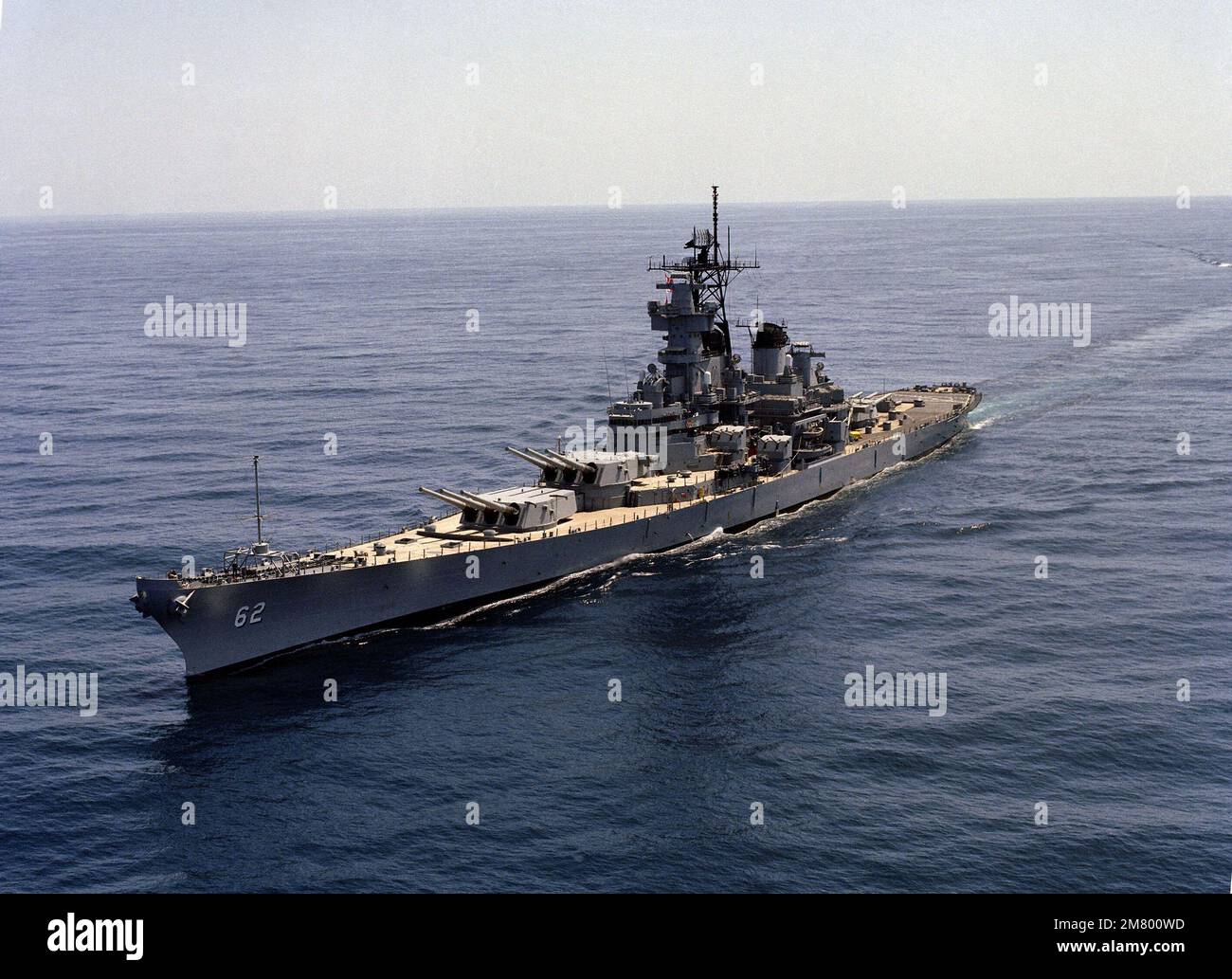 Aerial port bow view of the battleship USS NEW JERSEY (BB 62) underway ...