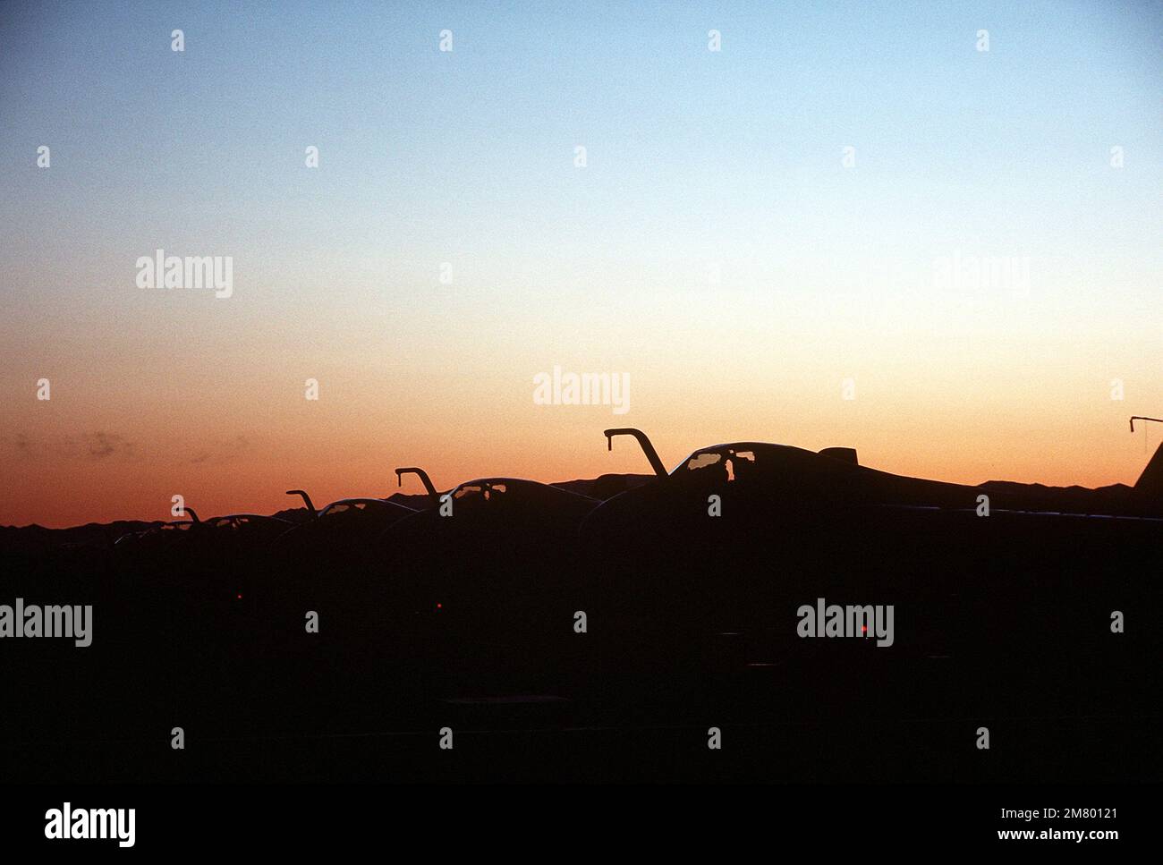A silhouetted left front view of A-6E Intruder aircraft from Carrier ...